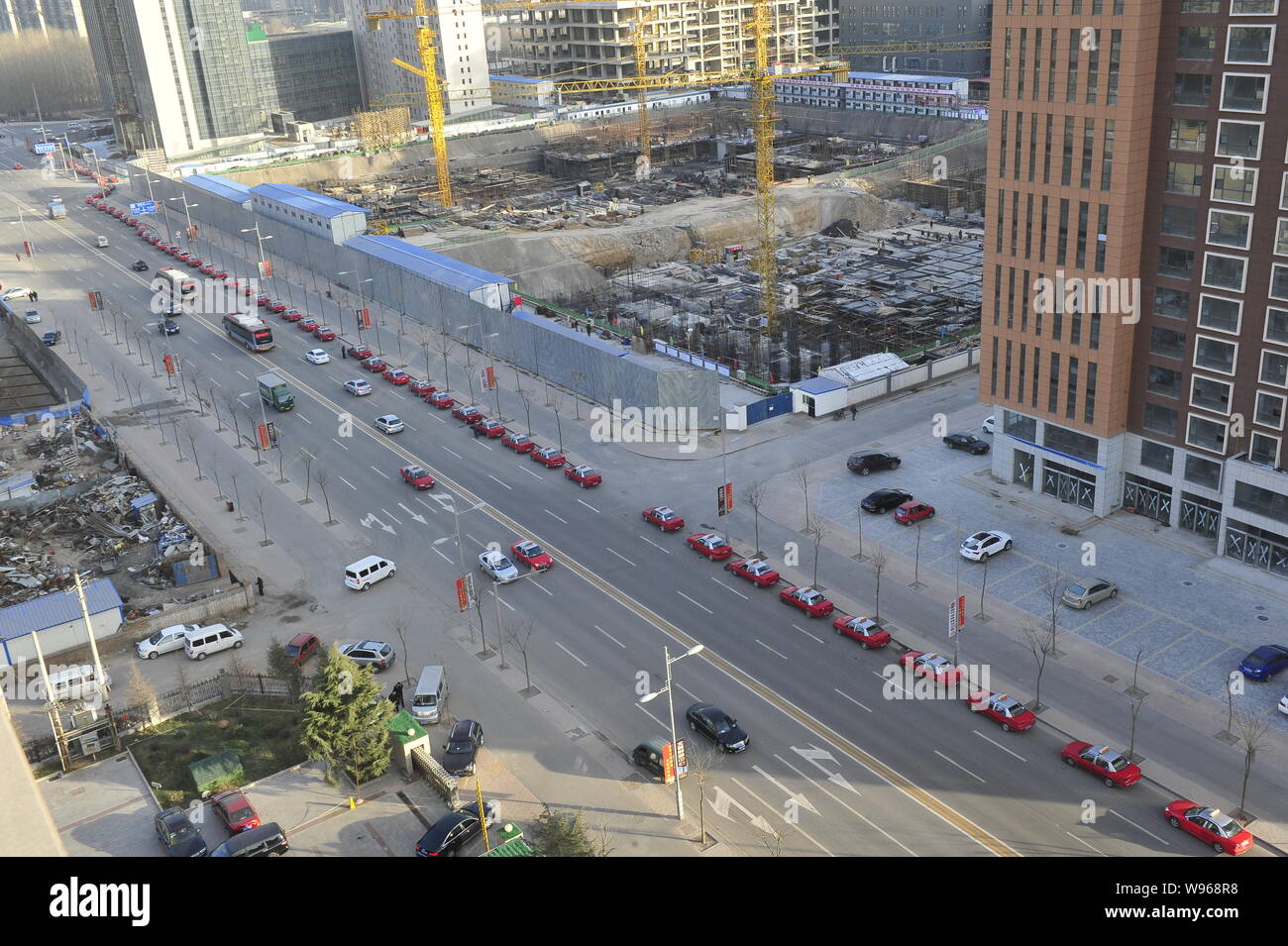 Aerial view of a long queue of taxis waiting to be refueled with ...