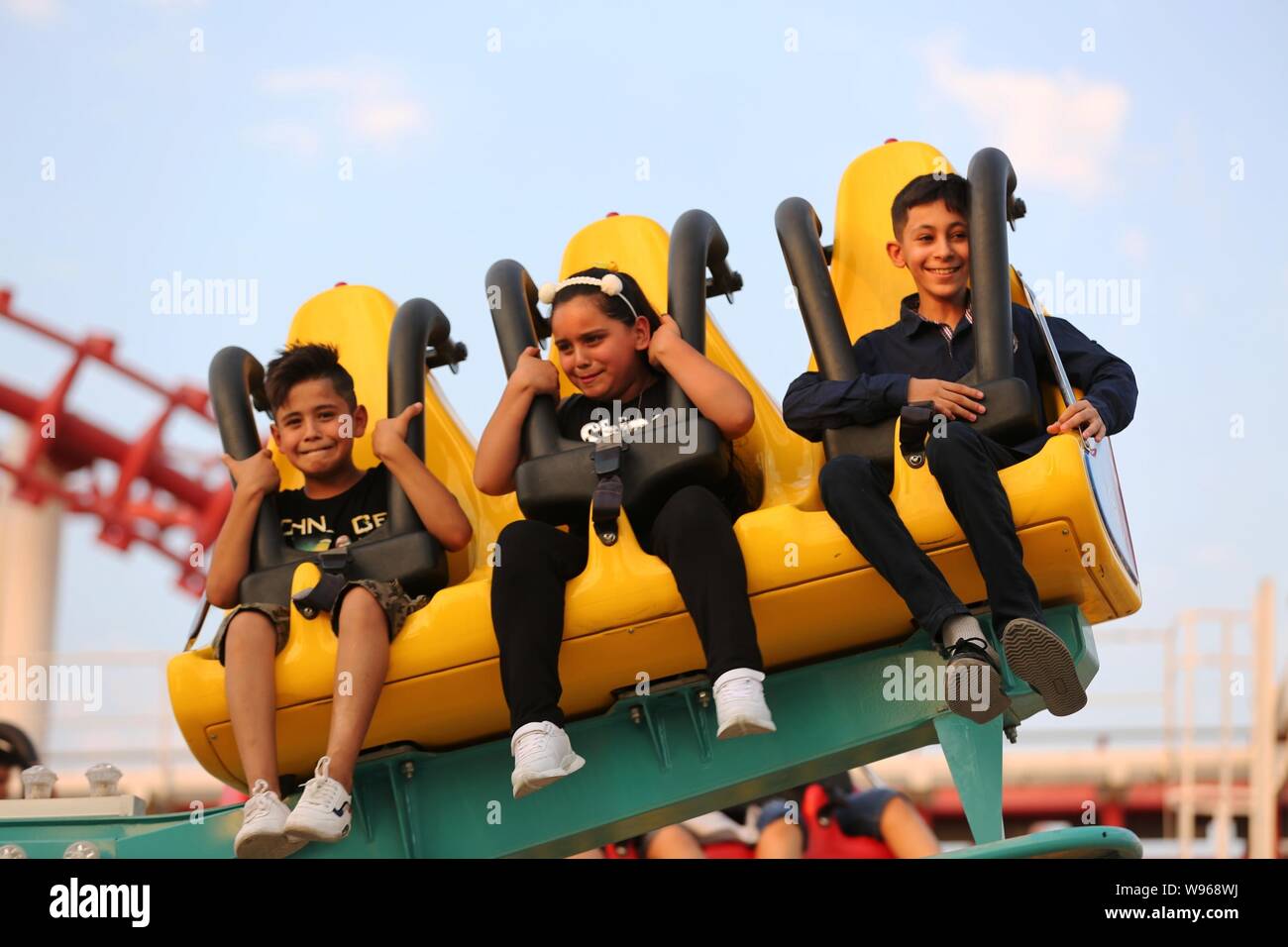 Baghdad, Iraq. 12th Aug, 2019. Iraqis play at an amusement park as they ...