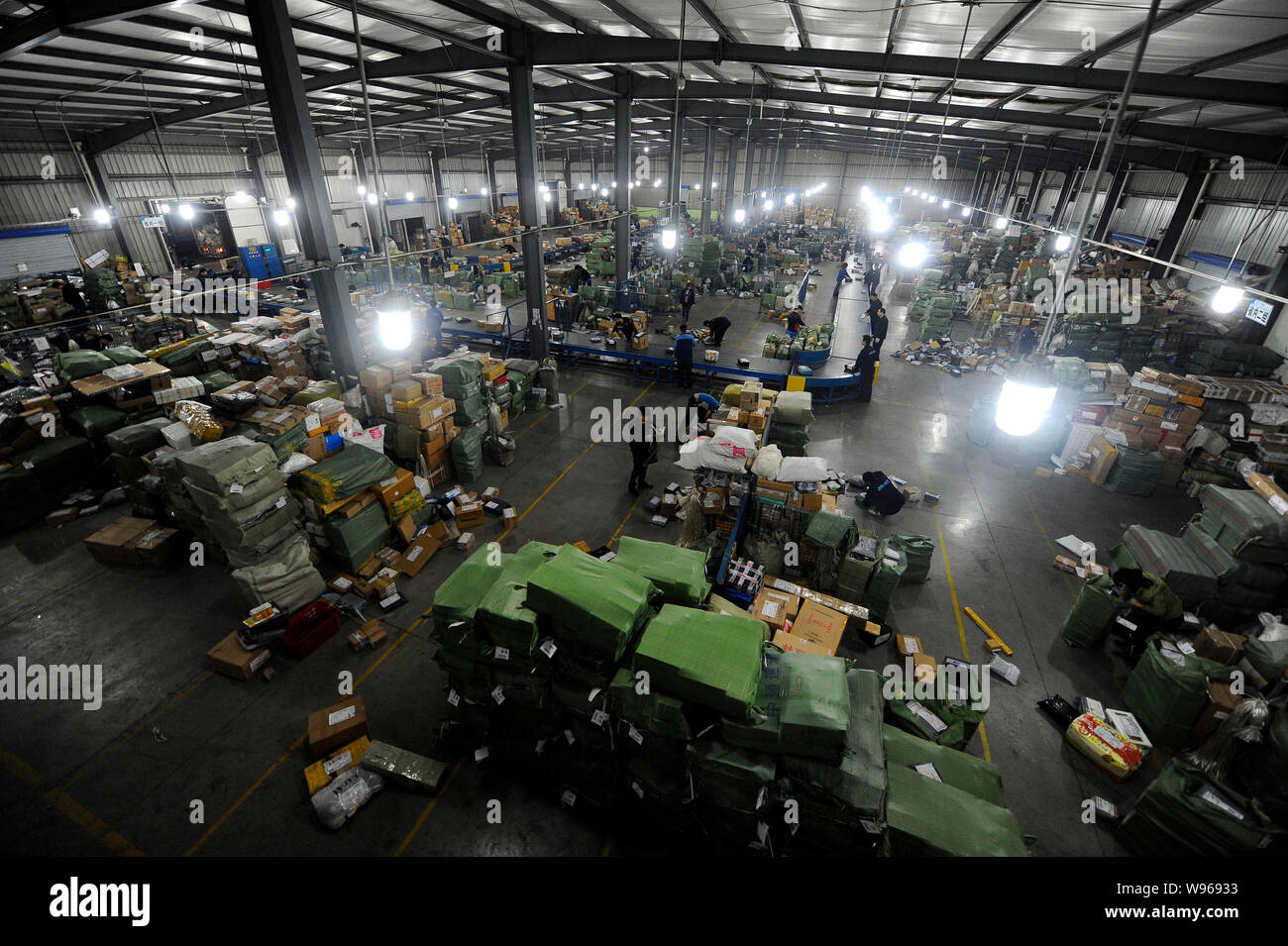 Chinese workers sort parcels from online shopping on the Singles Day at a dispatch center of ZTO ...