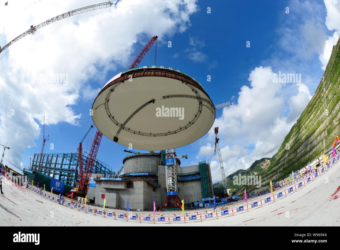 The dome of a containment structure is being hoisted at the Taishan ...