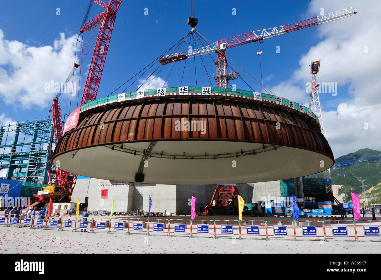 The dome of a containment structure is being hoisted at the Taishan ...