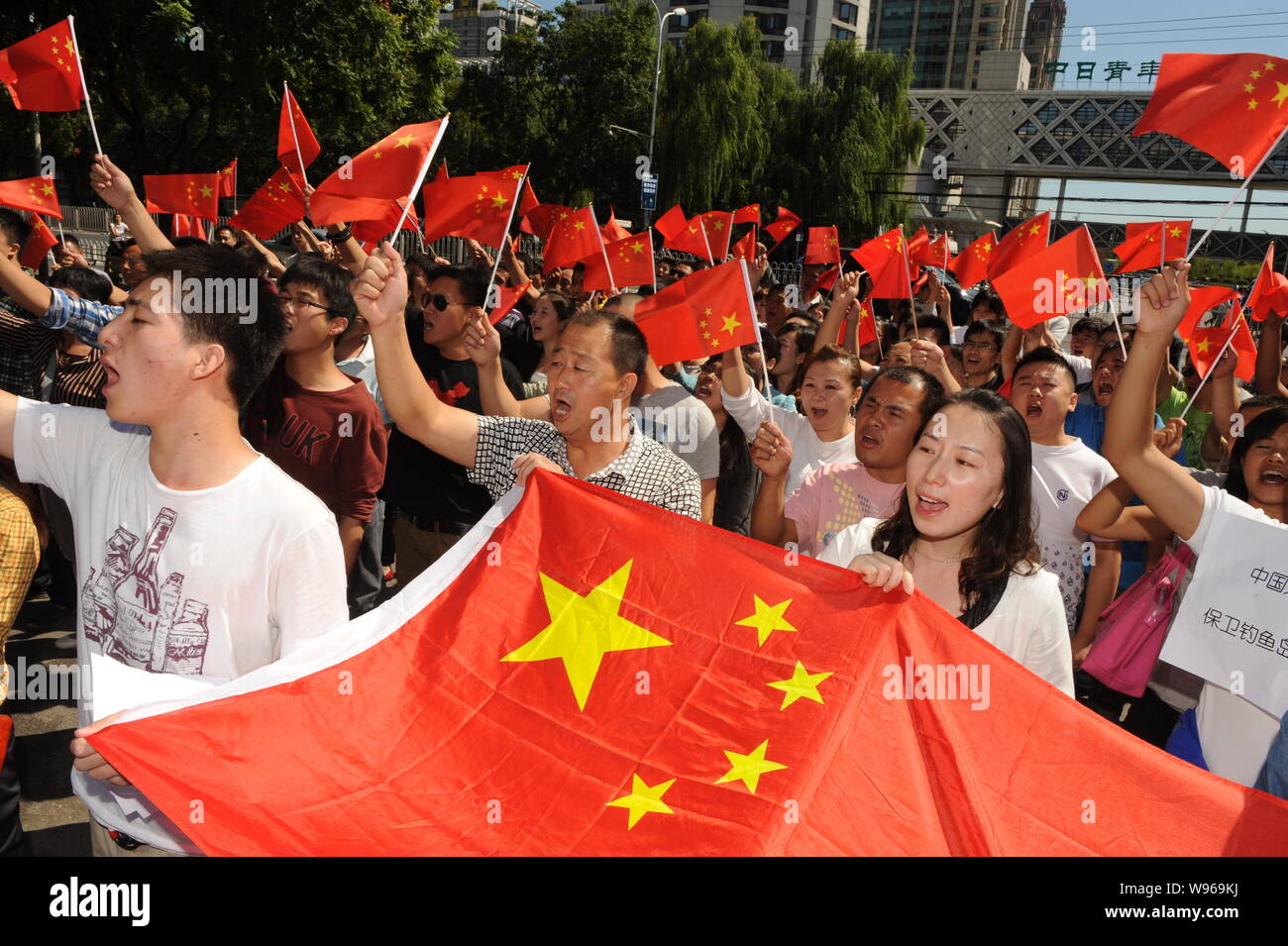Chinese protestors wave Chinese national flags and shout slogans during ...
