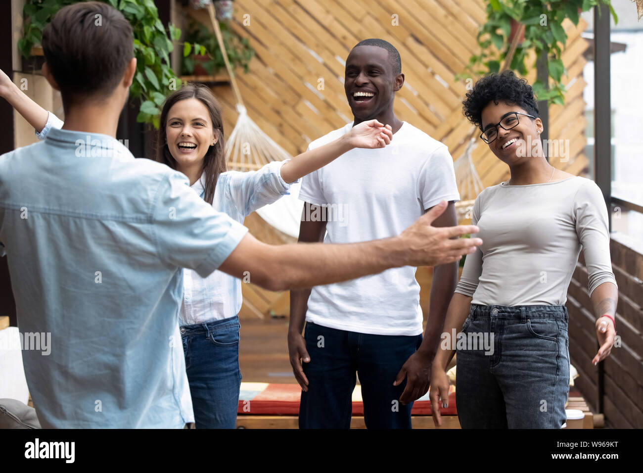 Happy multiracial friends feel excited meeting friend in cafe Stock ...