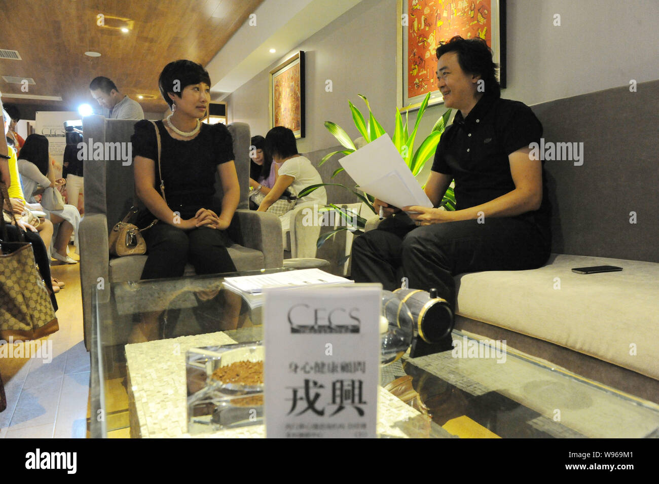 A Chinese consultant, right, interviews a young woman during a ...