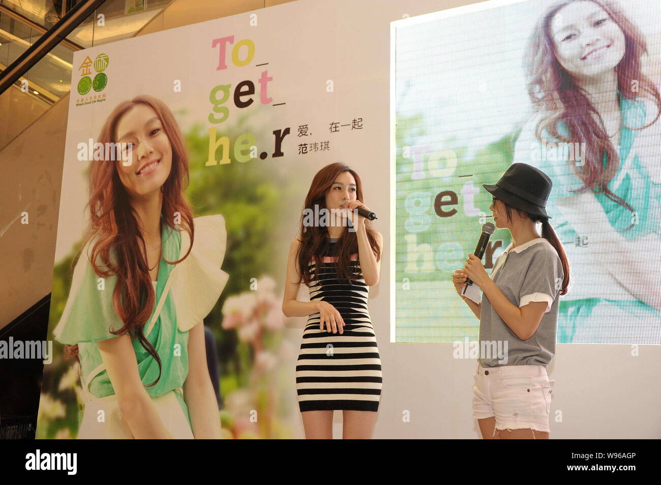 Taiwanese singer Fan Fan (L) performs with a fan during a signing ...