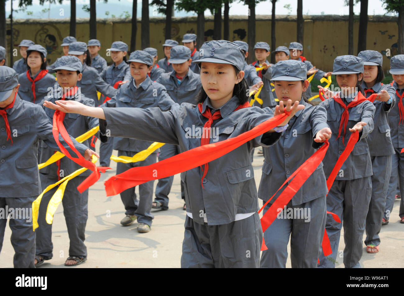 Students wearing uniforms of the Chinese Red Army dance during class ...
