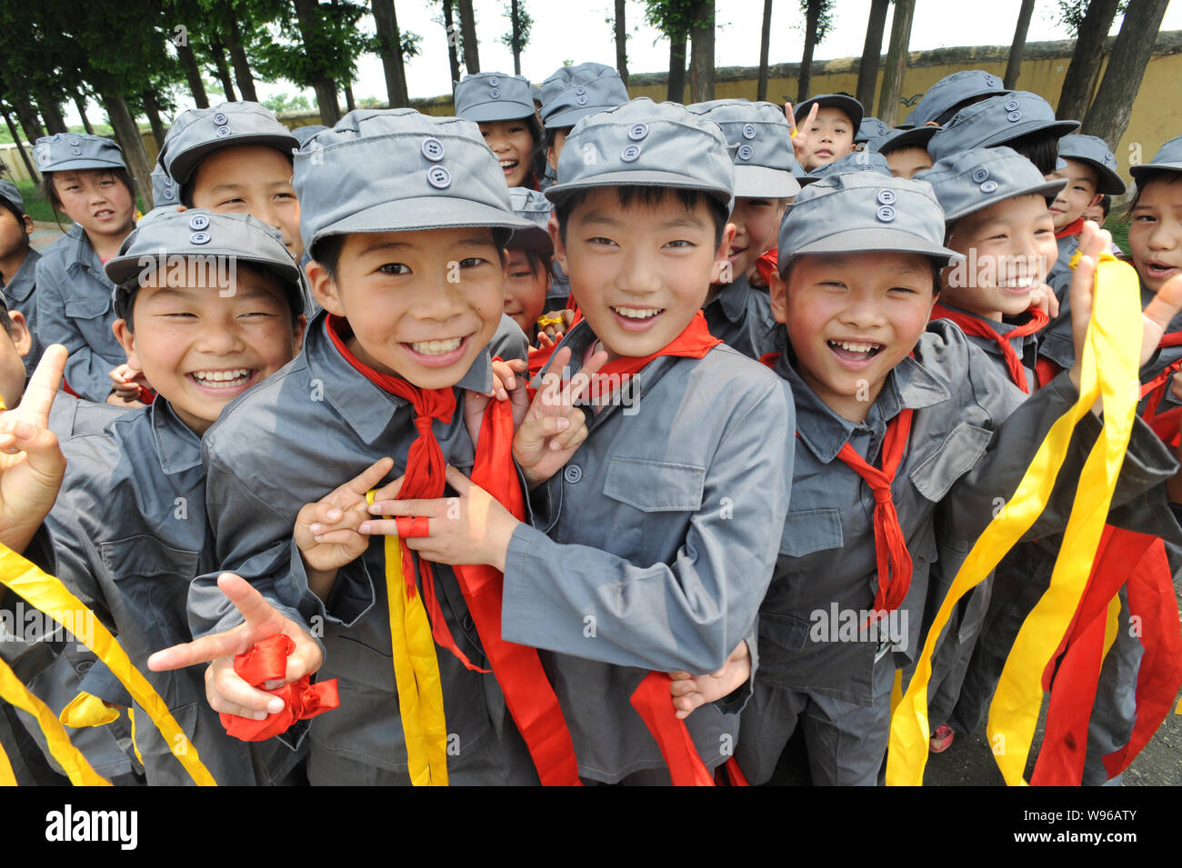 Students wearing uniforms of the Chinese Red Army pose during class ...