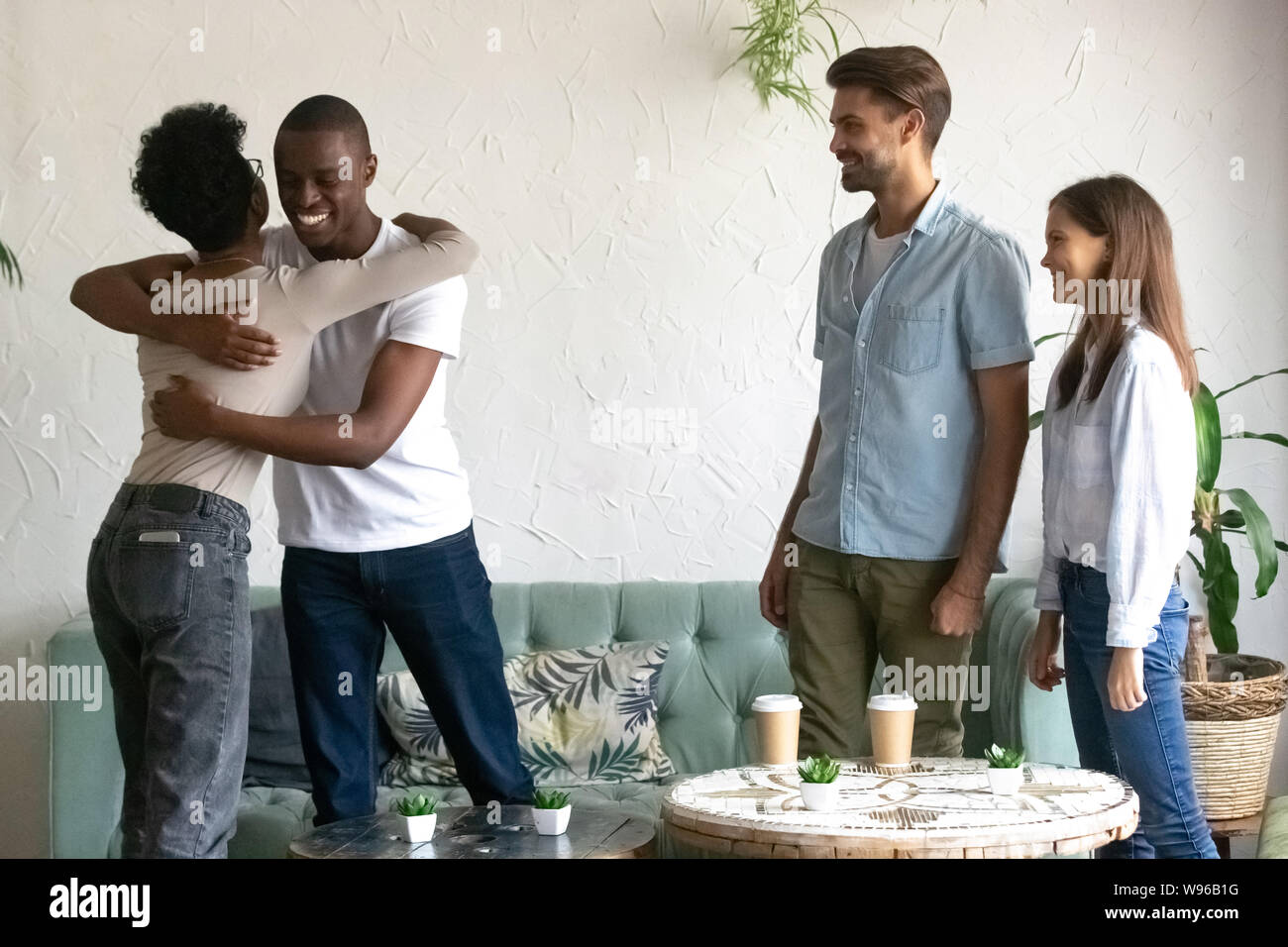 Smiling multiethnic friend get acquainted meeting outside Stock Photo ...
