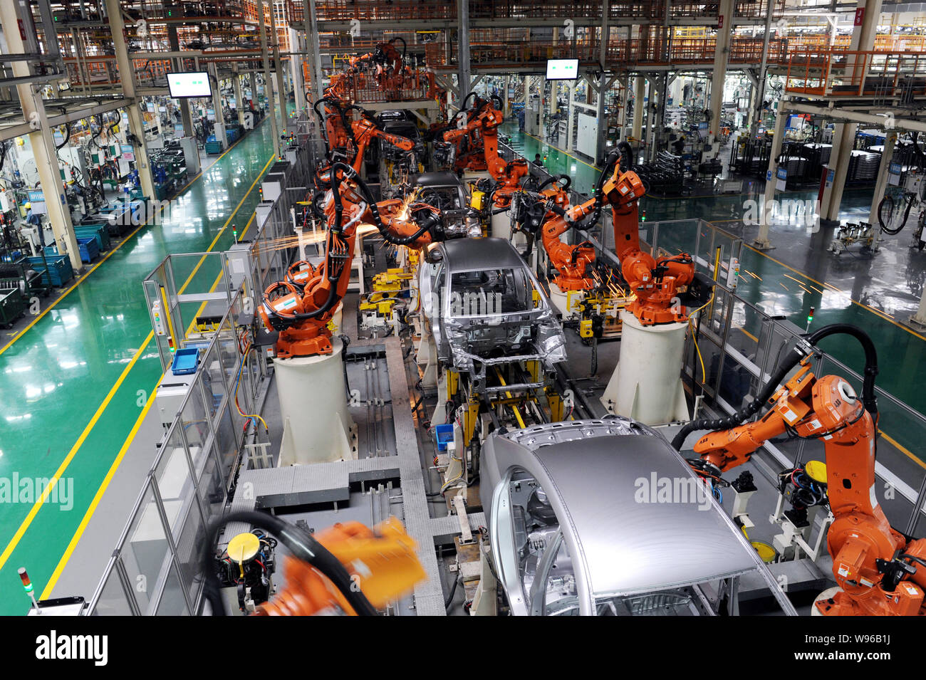 Robots weld bodies of Emgrand cars on the assembly line at an auto ...