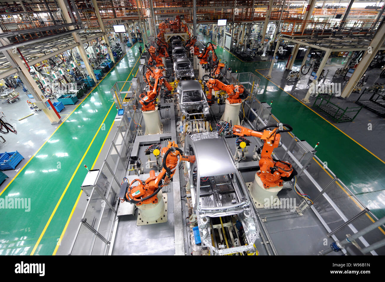 Robots weld bodies of Emgrand cars on the assembly line at an auto ...