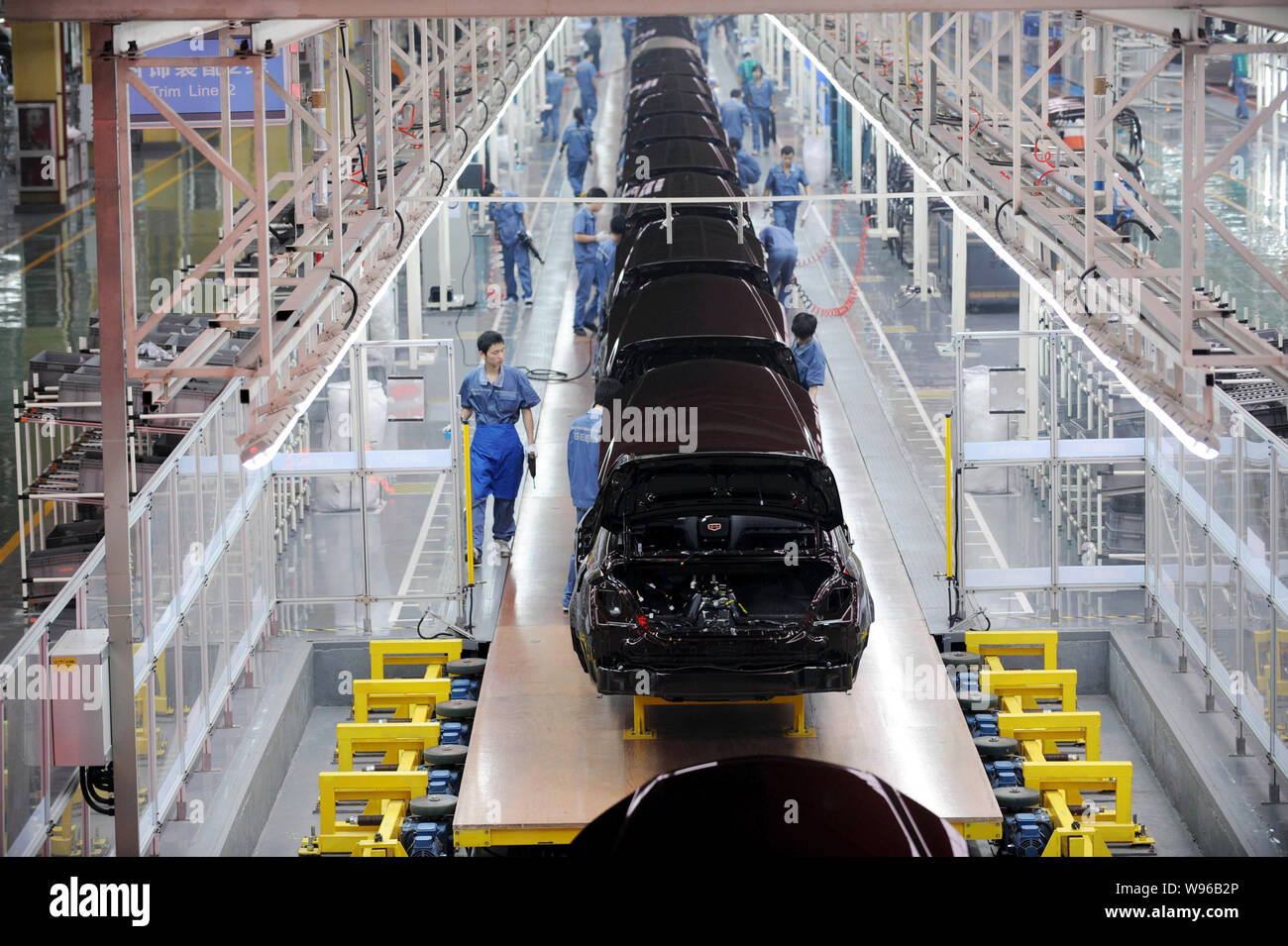 Chinese factory workers assemble Emgrand cars on the assembly line at ...