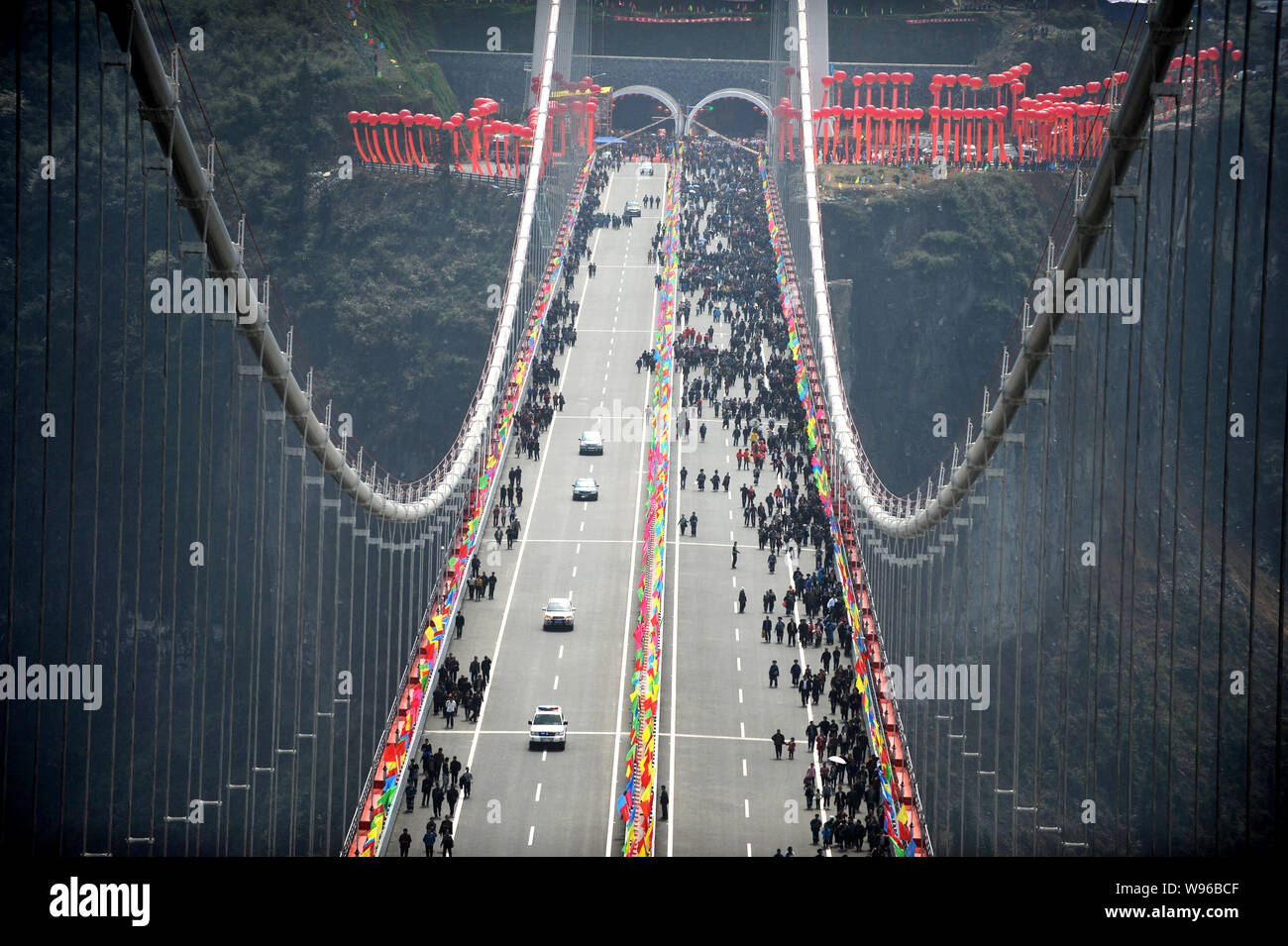 Visitors and vehicles pass through Aizhai Suspension Bridge in Aizhai ...