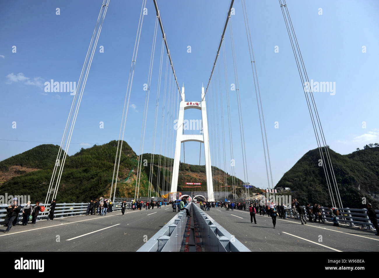 Visitors pass through Aizhai Suspension Bridge in Aizhai town, Jishou ...