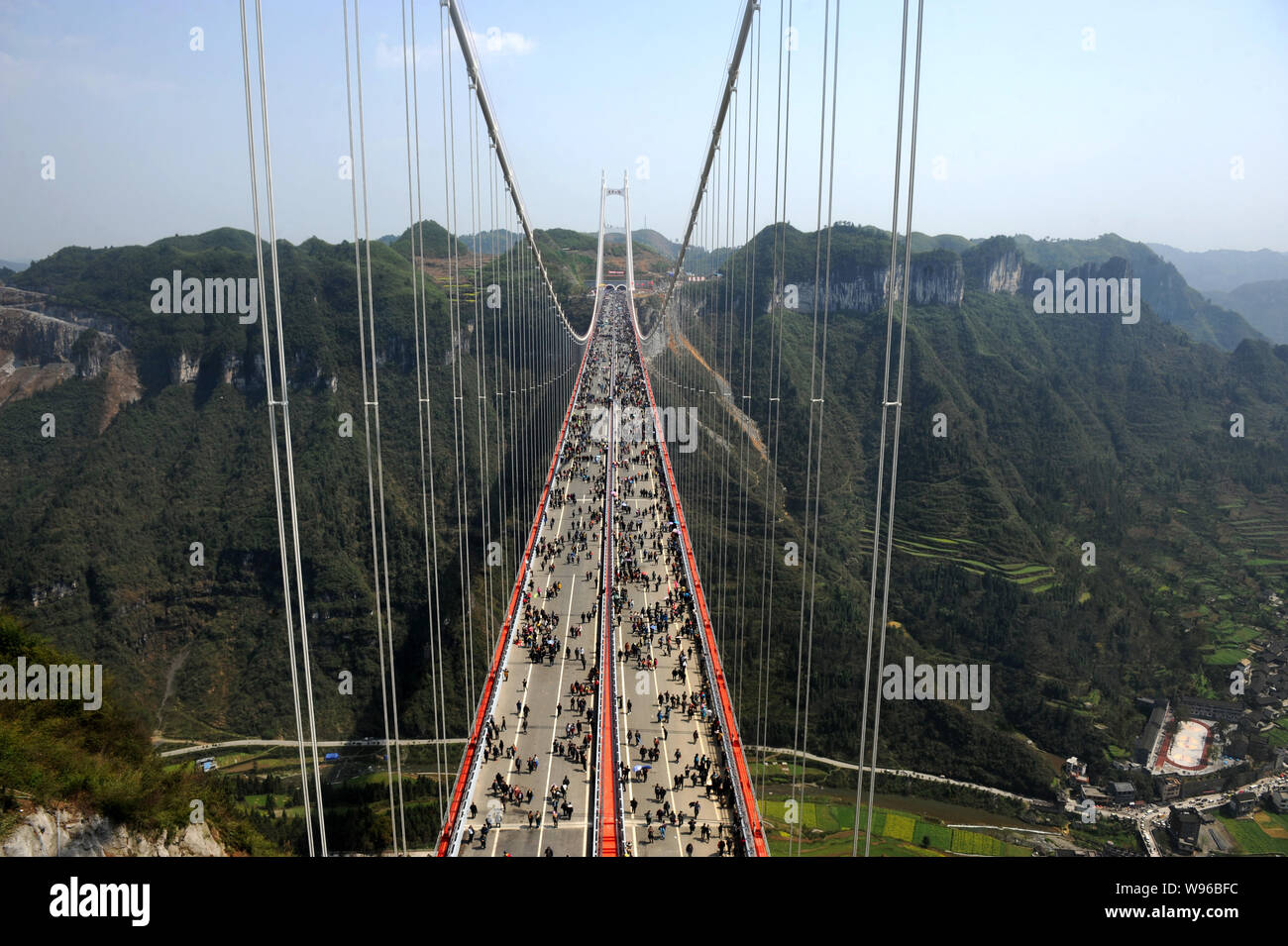 Visitors pass through Aizhai Suspension Bridge in Aizhai town, Jishou ...