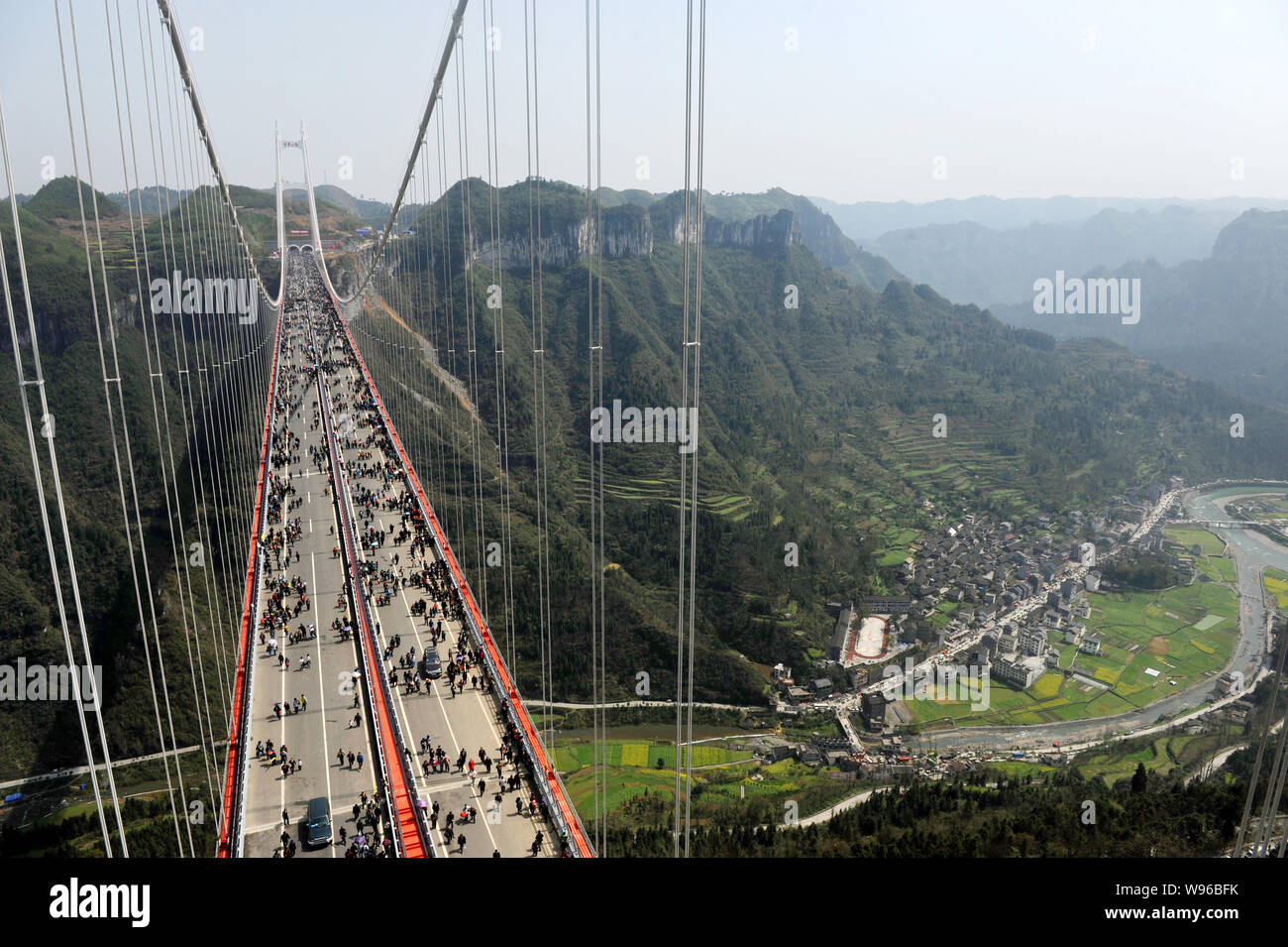 Visitors pass through Aizhai Suspension Bridge in Aizhai town, Jishou ...
