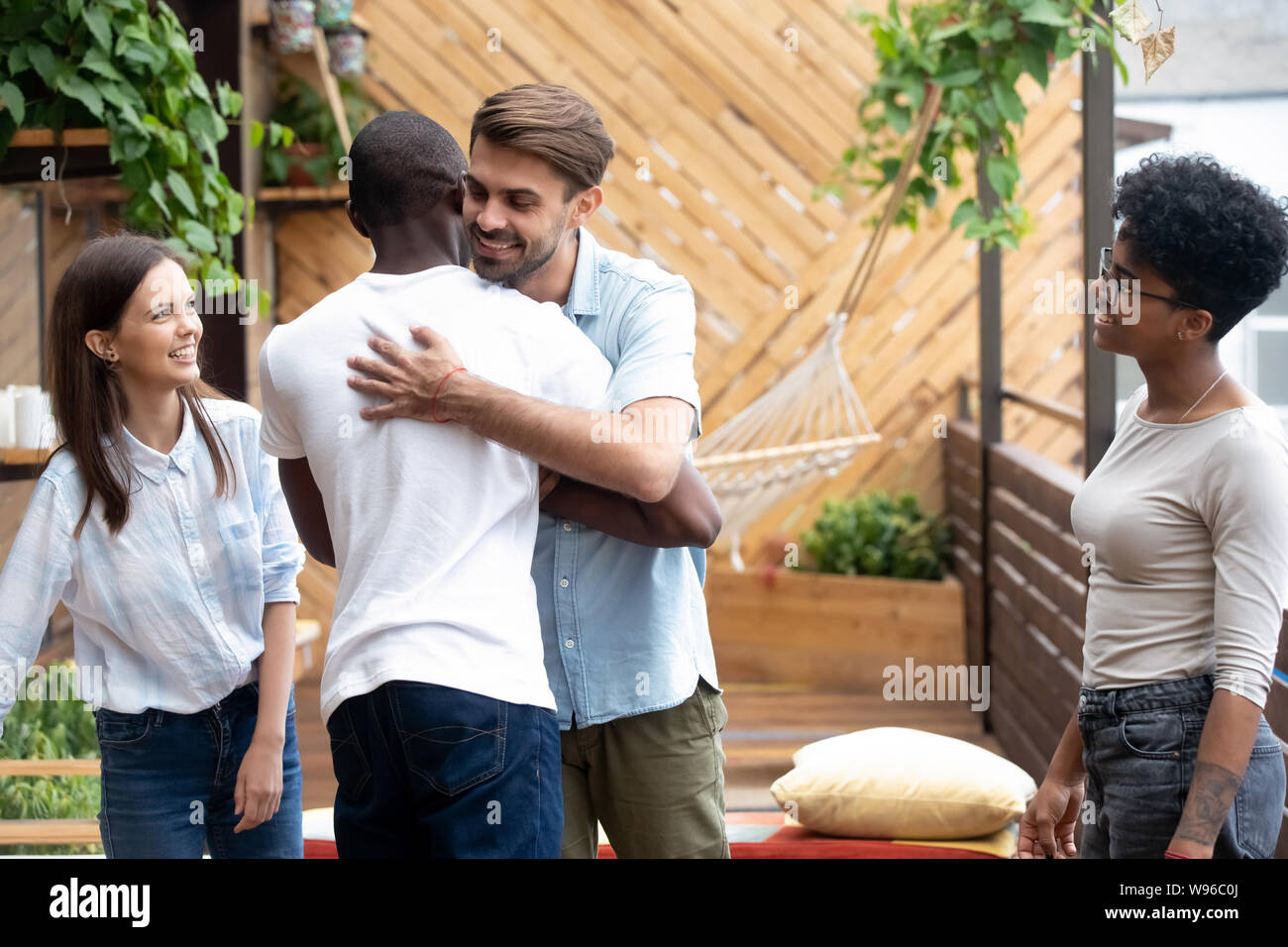 Happy diverse male friends hug meeting at friendly gathering Stock ...