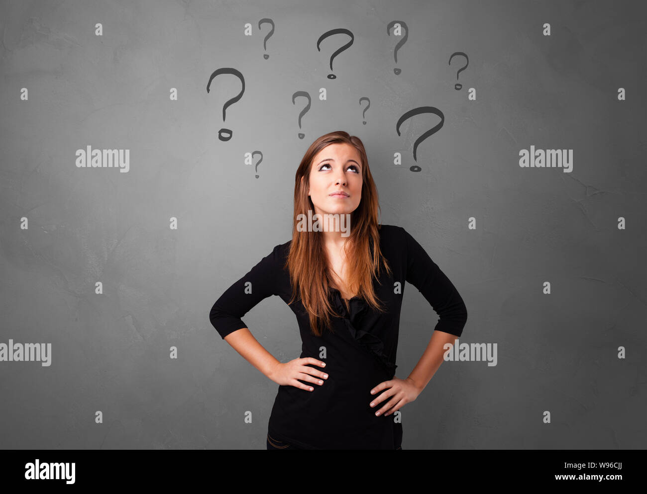 Person with question marks around face Stock Photo - Alamy