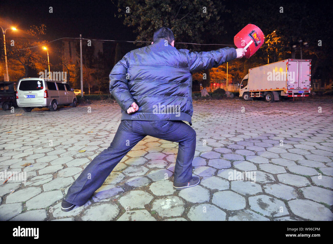 A Chinese man mimics the hand signals of flight deck crew directing J ...