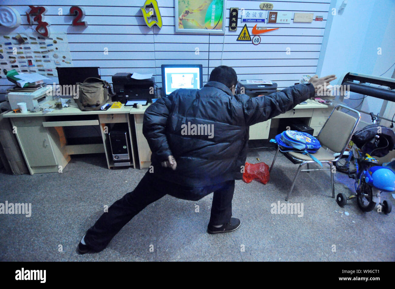 A Chinese man mimics the hand signals of flight deck crew directing J ...