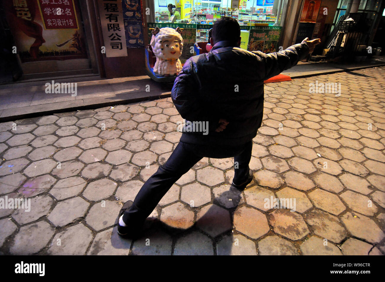 A Chinese man mimics the hand signals of flight deck crew directing J ...