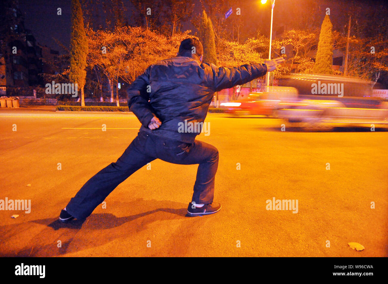 A Chinese man mimics the hand signals of flight deck crew directing J ...