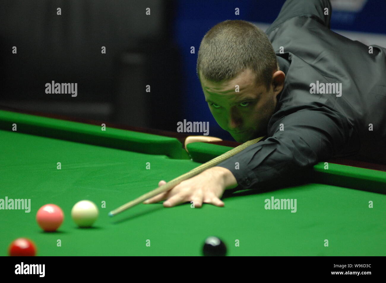 Jamie Jones of Wales plays a shot against John Higgins of Scotland ...