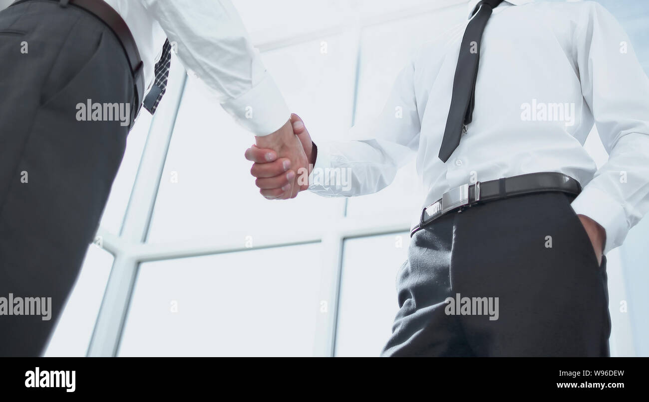 bottom view.handshake business people standing in the office Stock ...