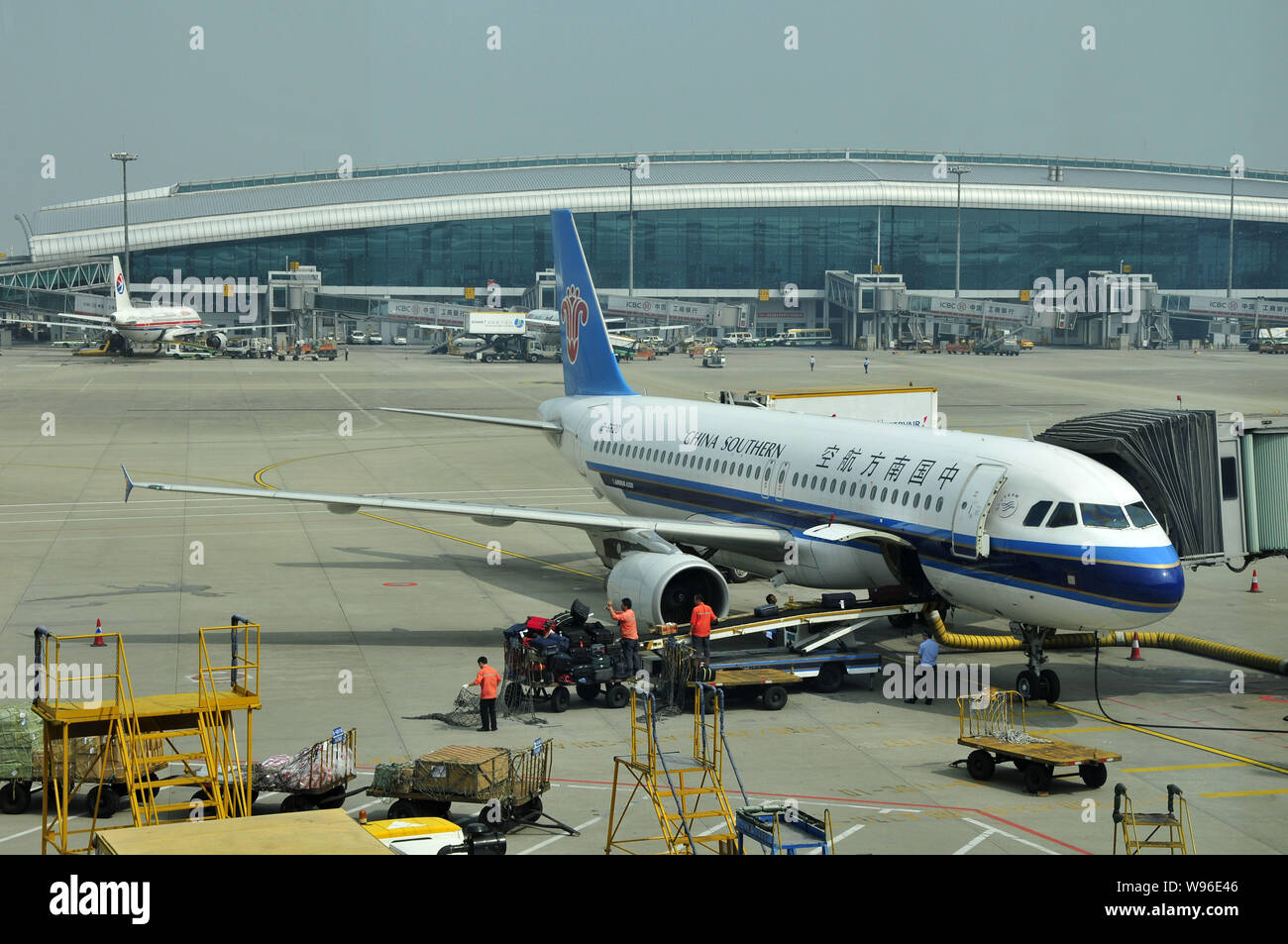 --FILE--Chinese workers unload luggages from an Airbus A320 jet plane ...