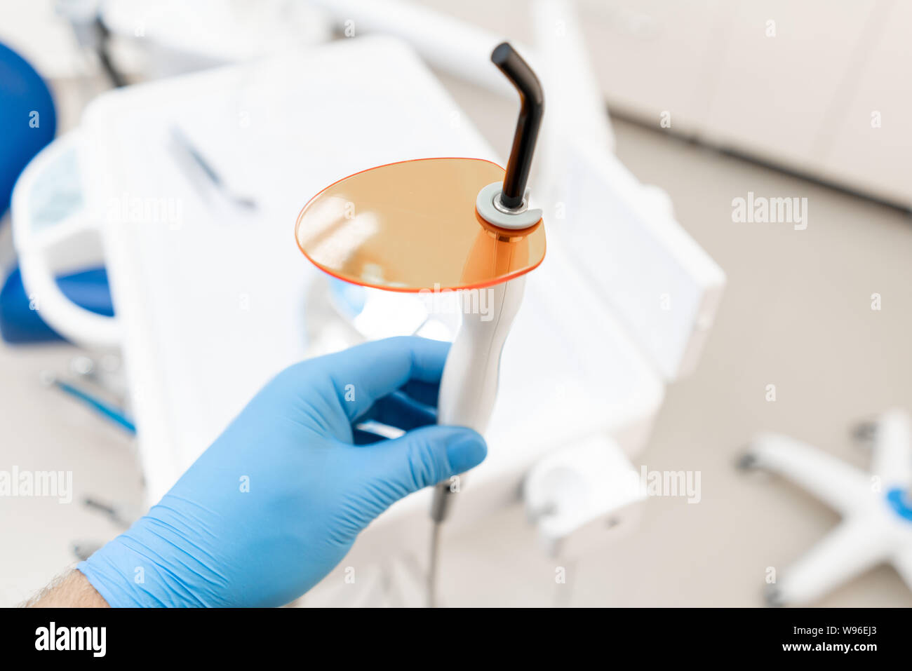 Dental polymerization lamp in dentist hand, with UV light and laser ...