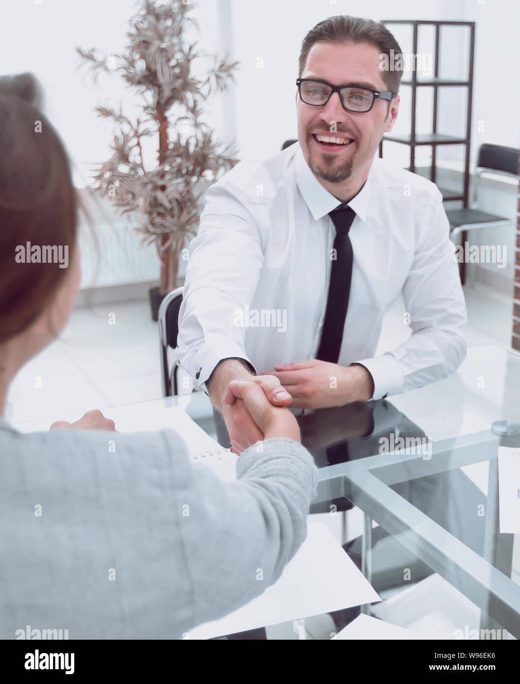 handshake financial partners sitting at the office Desk Stock Photo - Alamy