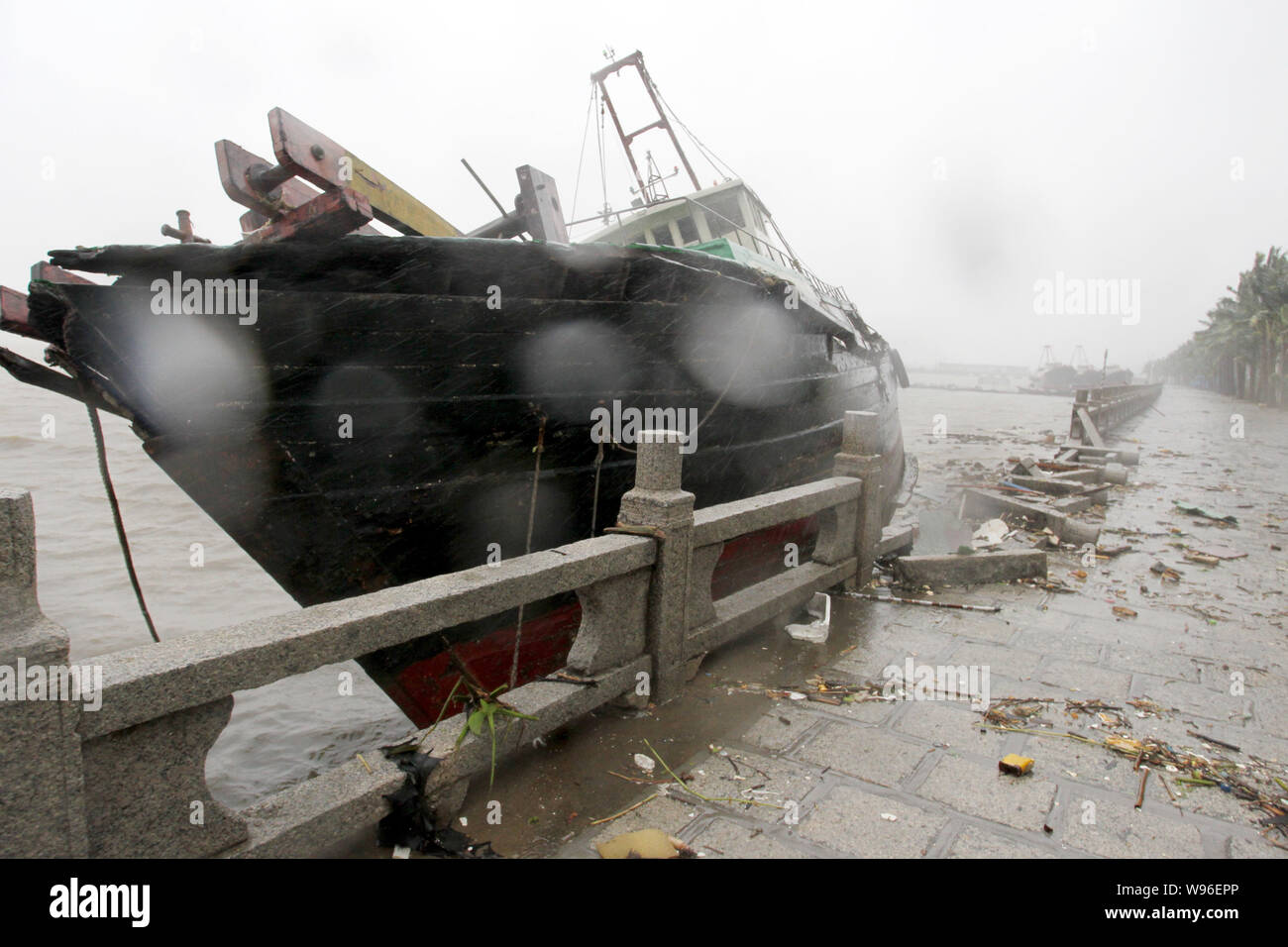 A fishing boat being pushed by strong wind from Typhoon Vicente crashes ...