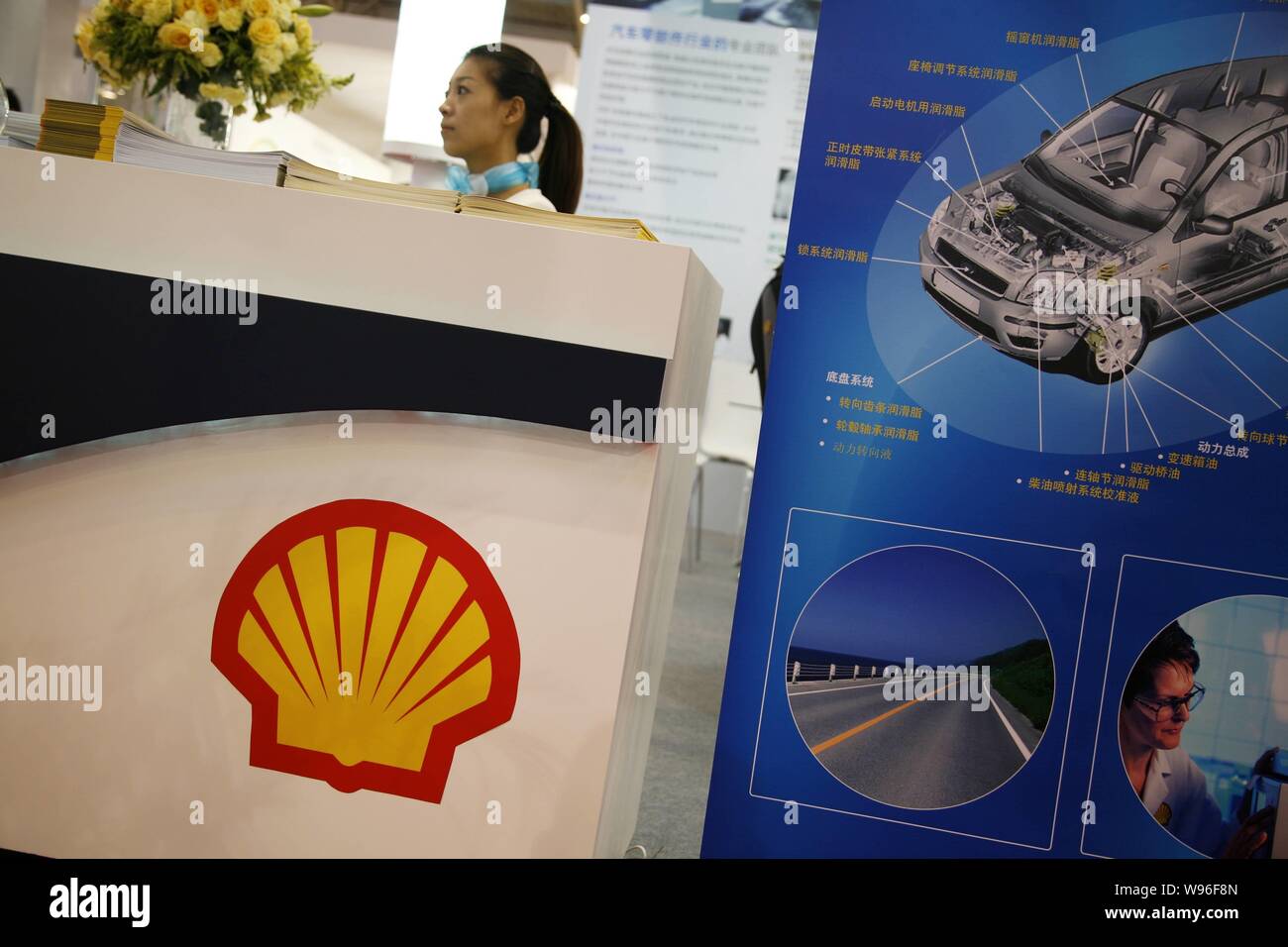 --FILE--A Chinese employee looks on at the stand of Shell during an ...