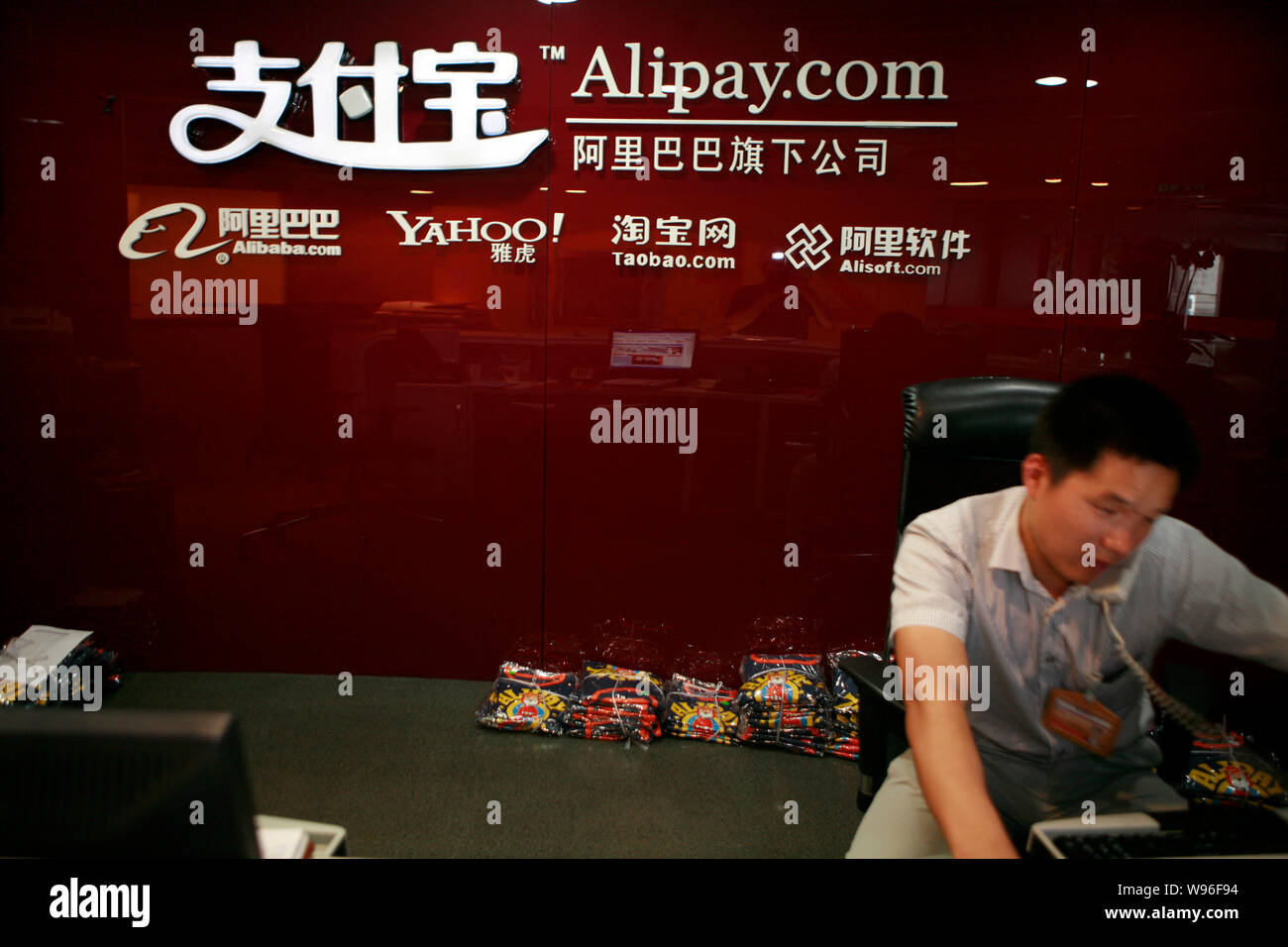 --FILE--A Chinese employee talks on telephone at the counter of the ...