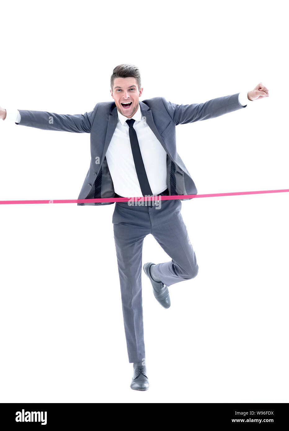 Happy businessman running through finishing line Stock Photo - Alamy