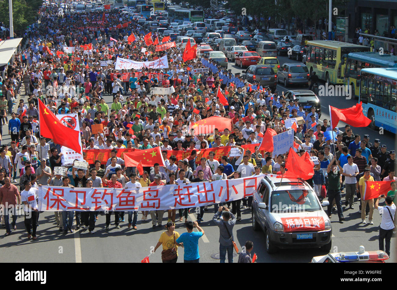 Chinese protestors wave Chinese national flags, hold up banners and ...