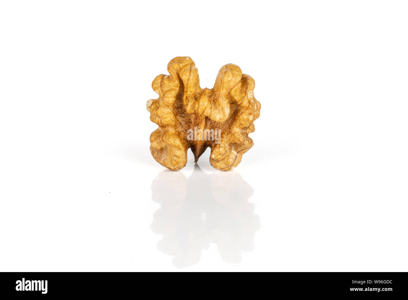 One whole ripe brown walnut without shell isolated on white background ...