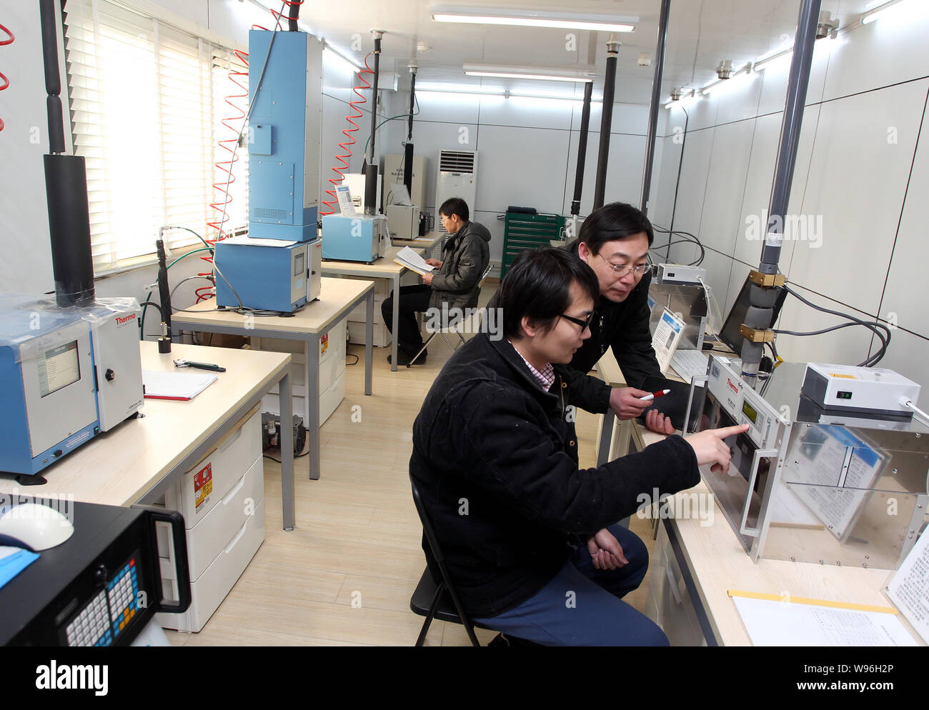 Chinese environmental monitoring workers test device for detecting PM2 ...