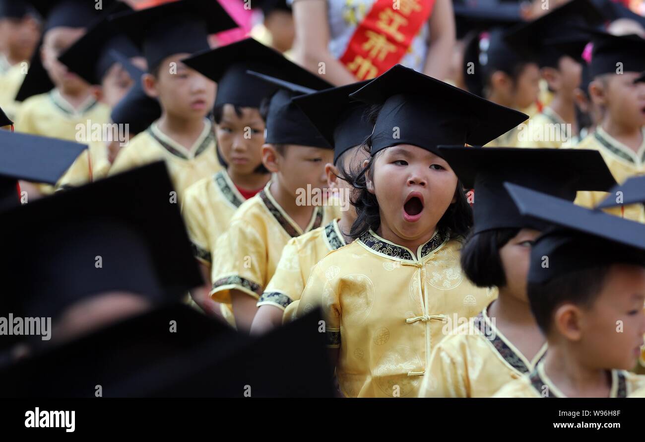 A young Chinese student dressed in a traditional costume and wearing an ...