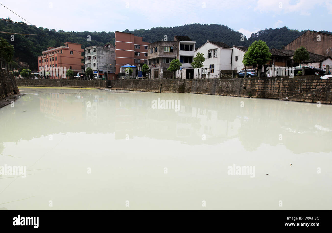 View of the milky Quxi River contaminated by latex in Linqiao village ...