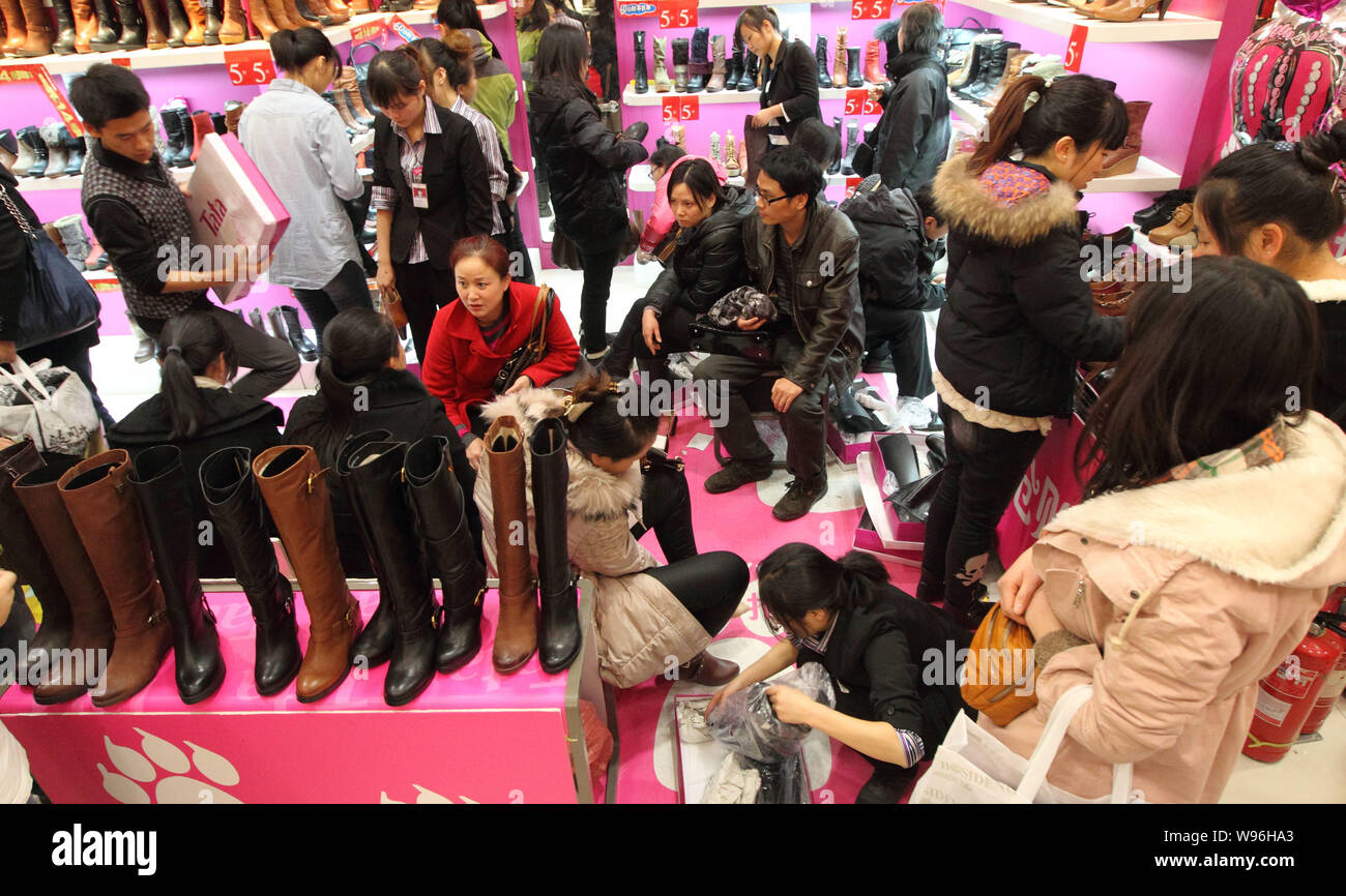 --FILE--Consumers shop at a shoe store in the New World Department ...