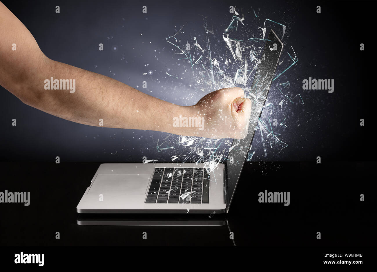 Hand hitting strongly laptop screen glass Stock Photo - Alamy