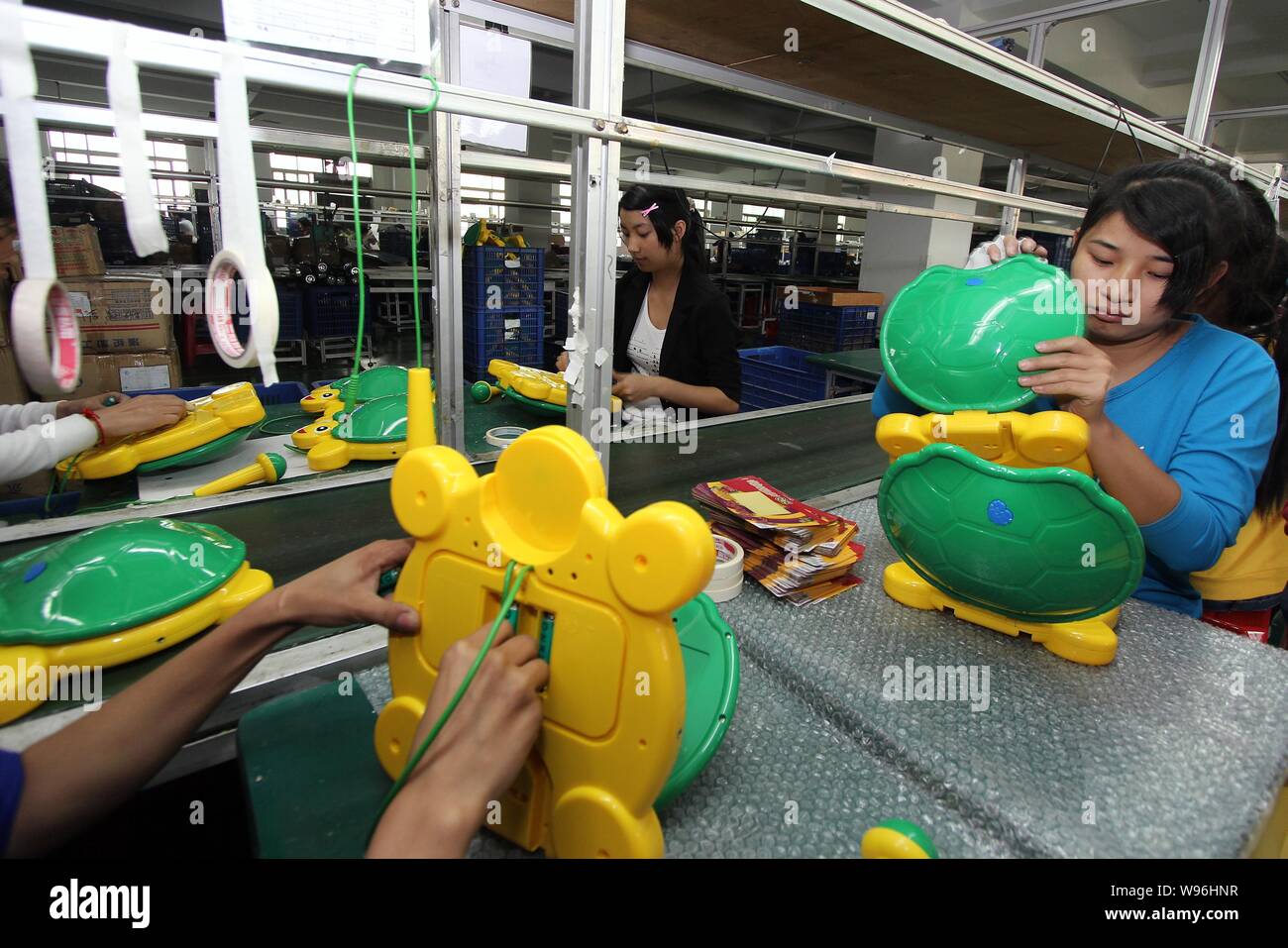--FILE--Female Chinese workers assemble toys on the production line at ...