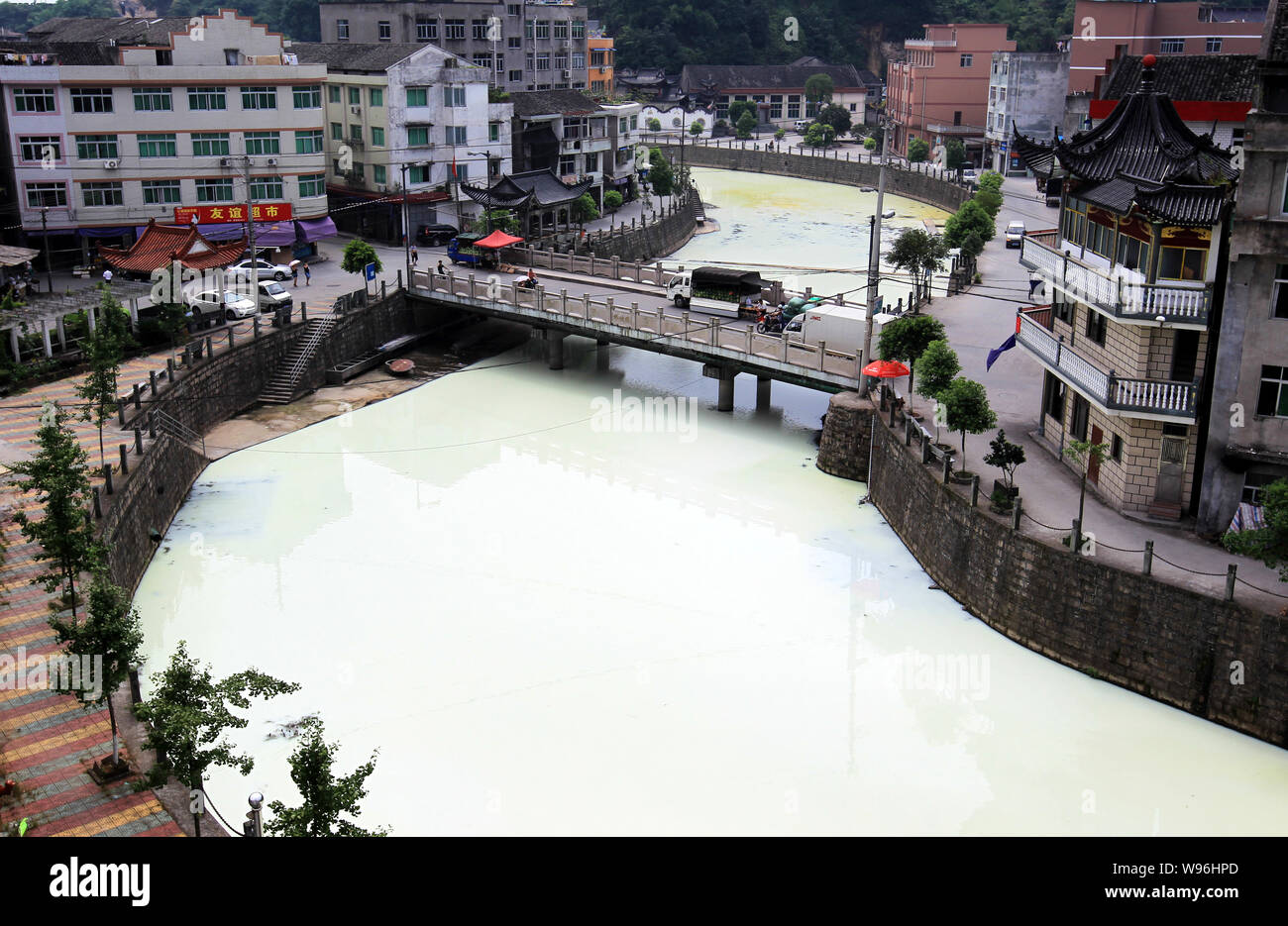 View of the milky Quxi River contaminated by latex in Linqiao village ...