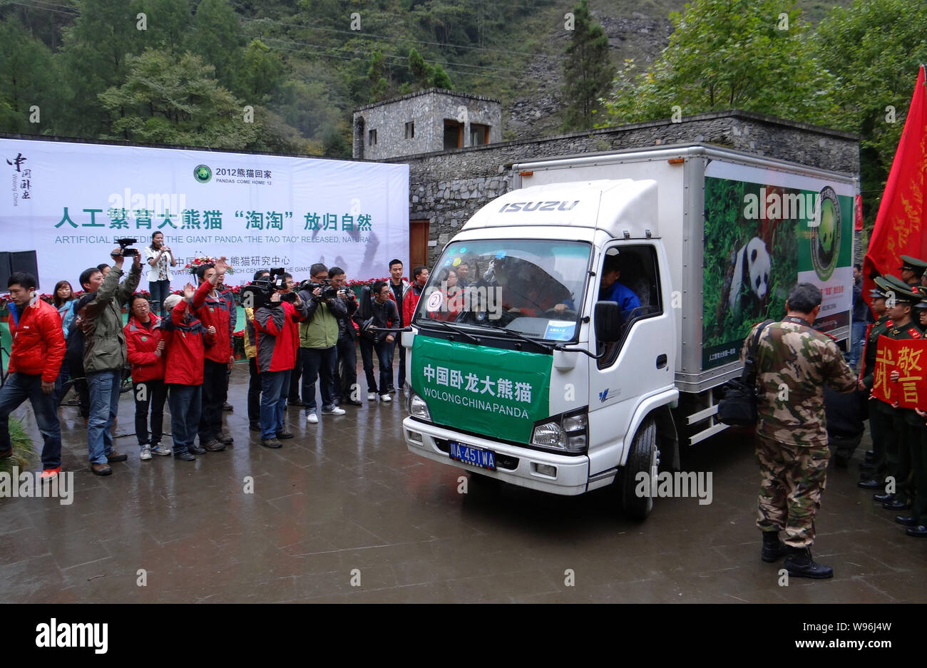 A van carrying giant panda Tao Tao to be released into the wild leaves ...