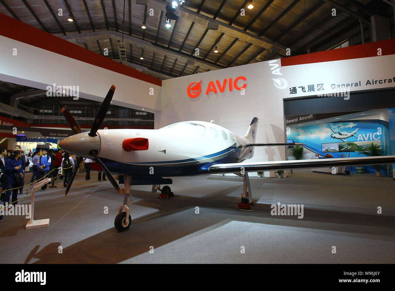 Visitors look at a turboprop plane of AVIC (Aviation Industry ...