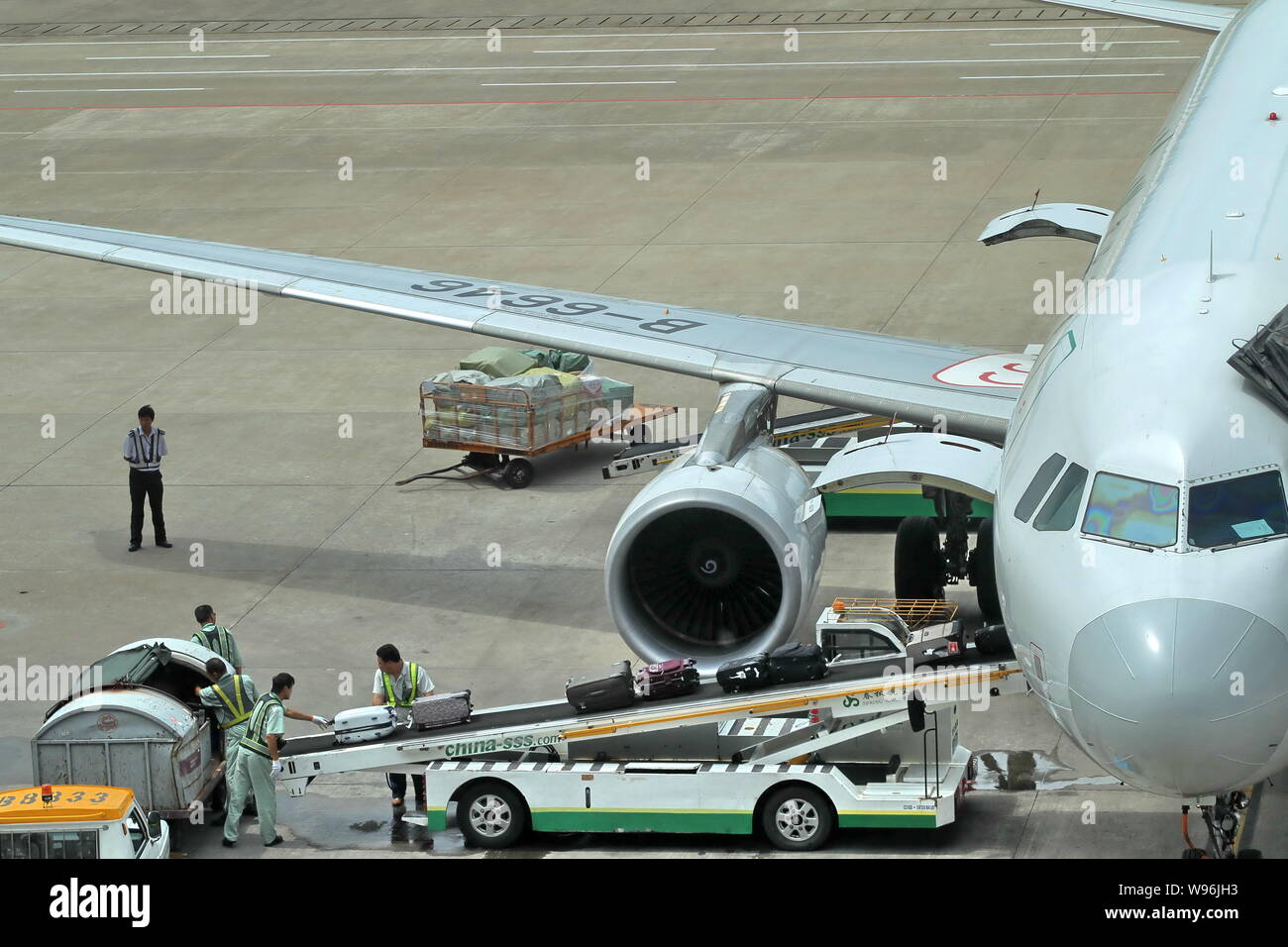 Passengers lugguge are pictured as being offloaded from a plane at ...