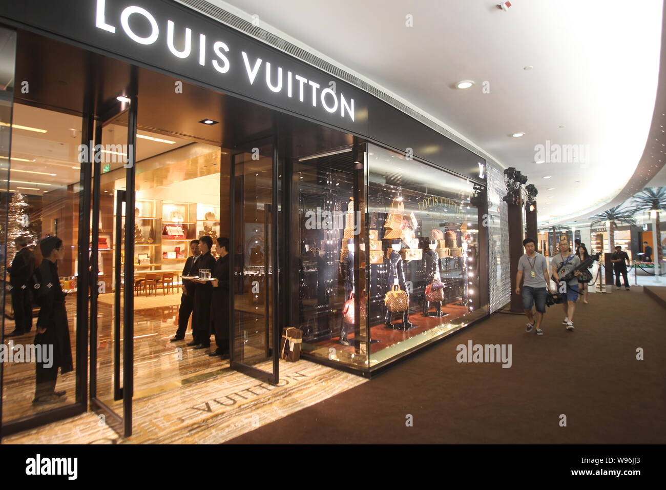Chinese staff are seen at the new flagship store of Louis Vuitton ...