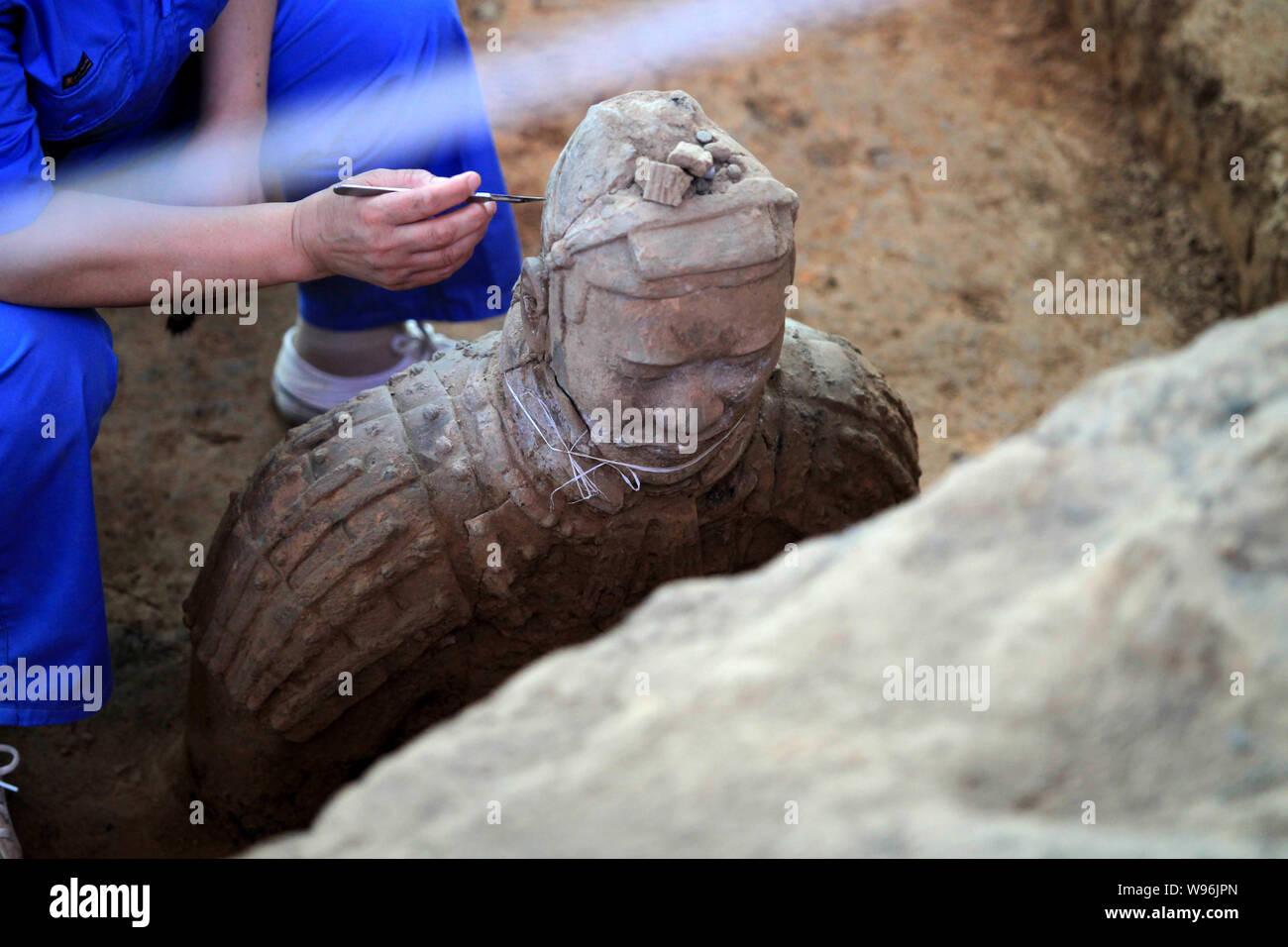 A Chinese archaeologist excavates a terracotta warrior in the No.1 Pit ...