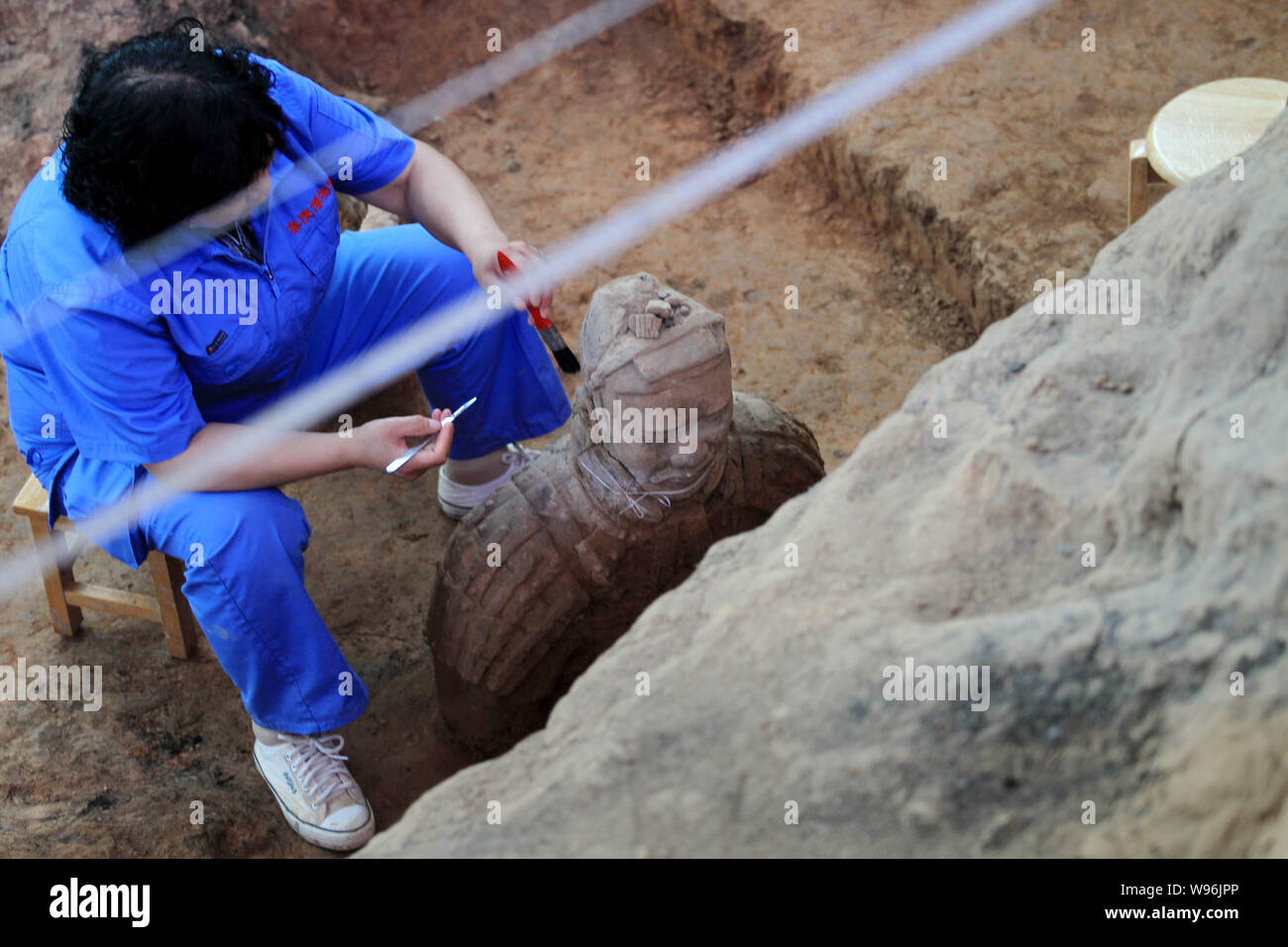 A Chinese archaeologist excavates a terracotta warrior in the No.1 Pit ...
