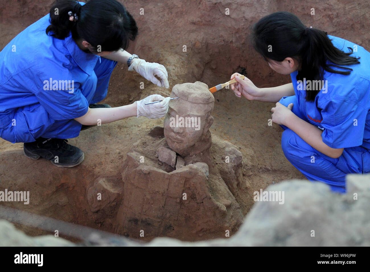 Chinese archaeologists excavate a terracotta warrior in the No.1 Pit at ...